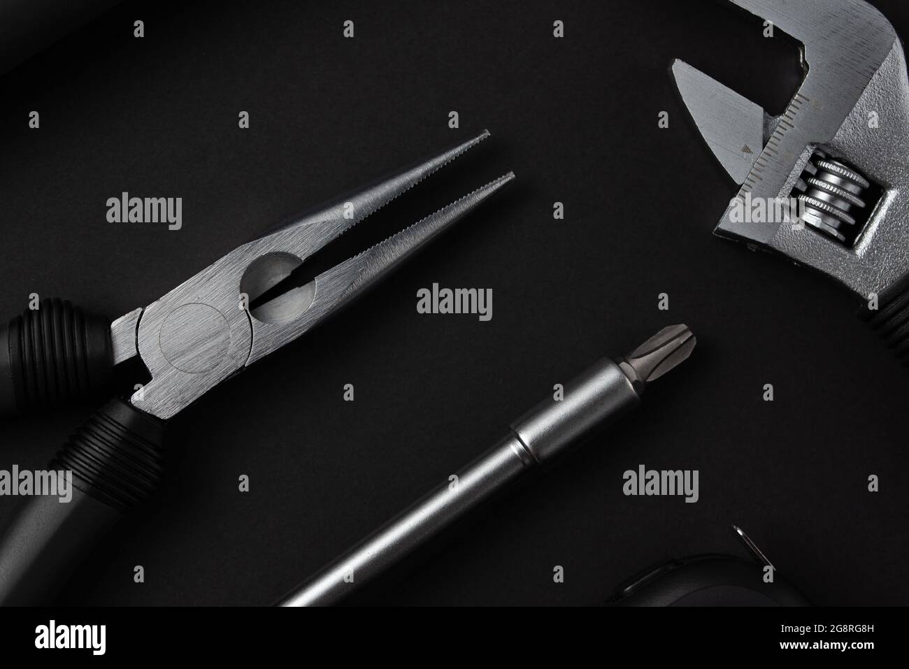 Black metal tools on black background Stock Photo - Alamy
