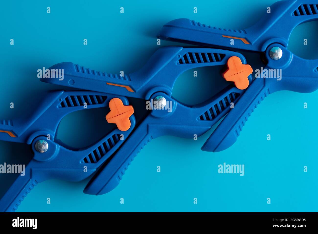 Isolated blue clamp tool on the blue background Stock Photo - Alamy