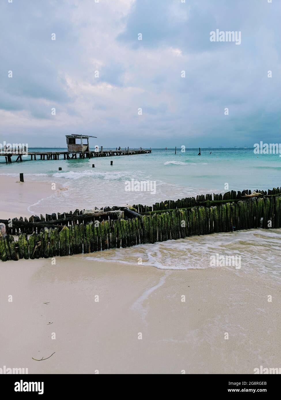 Peaceful sand beach by the ocean on a cloudy day Stock Photo - Alamy