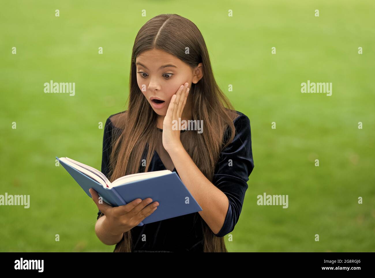 Surprise helps to study new things. Surprised child read study book ...