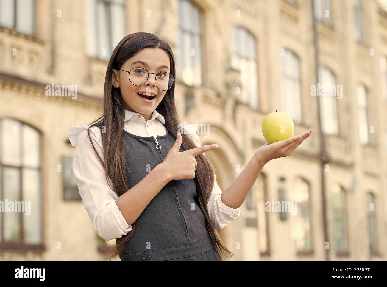 Great for your teeth. Little kid point finger at apple. School snack ...
