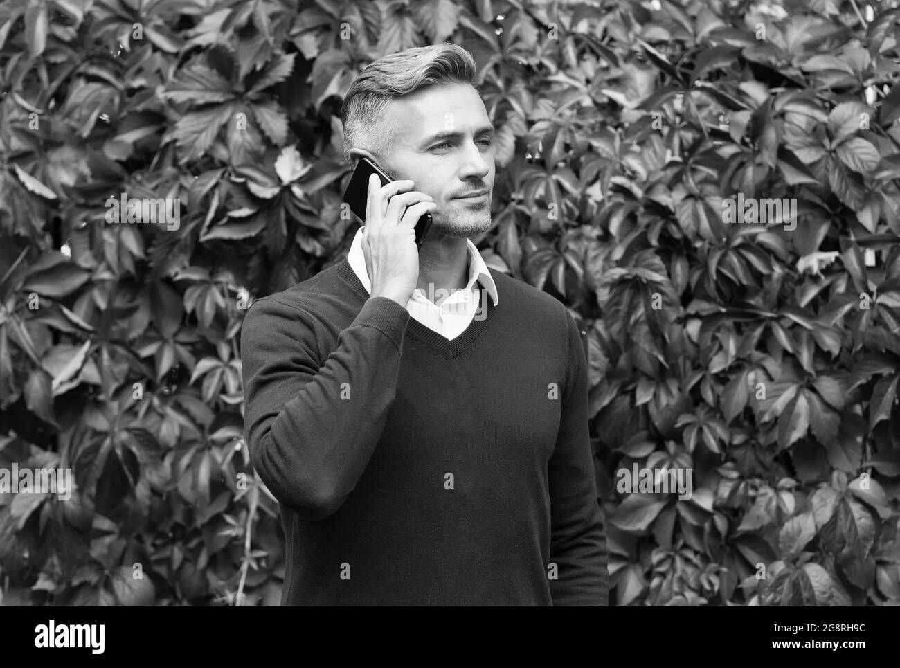 Confident businessman using phone Black and White Stock Photos & Images ...