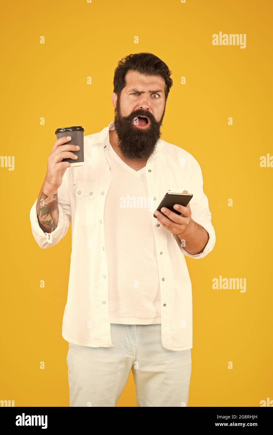 confused bearded man wearing wearing use mobile phone for online ...