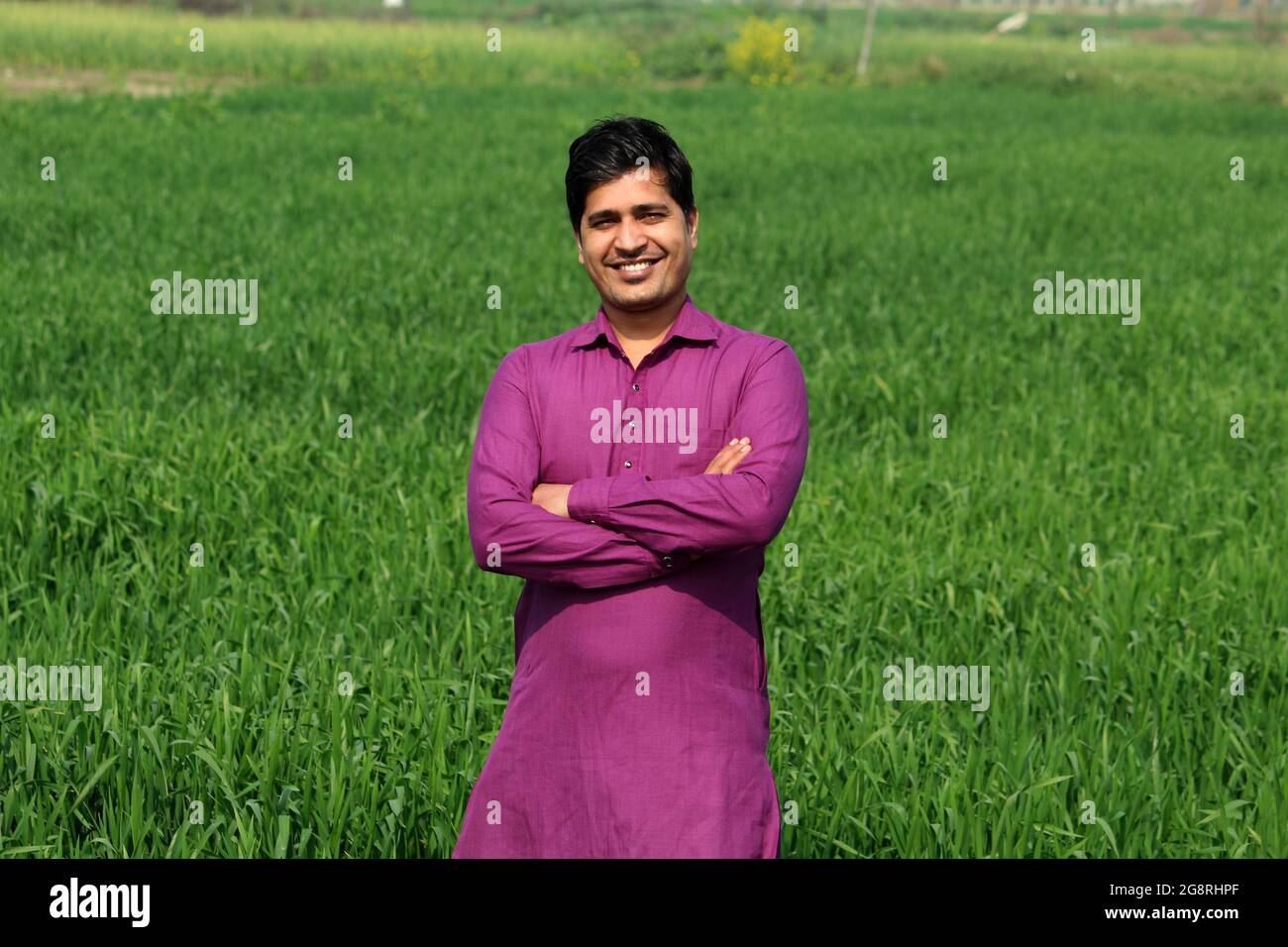 worry less ,indian farmer standing hand folded in his healthy wheat ...