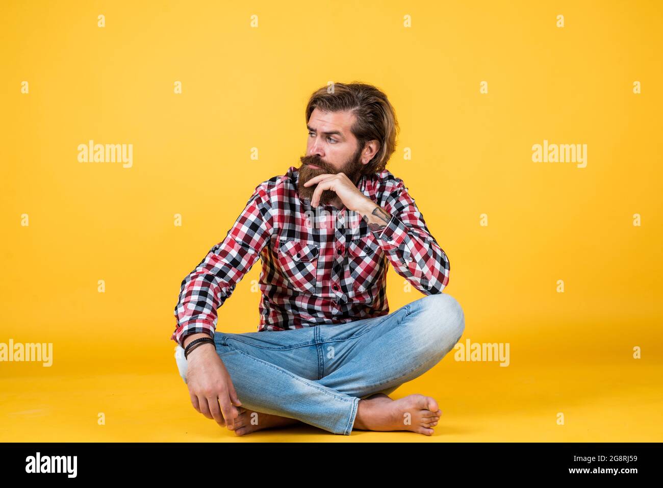 serious handsome bearded guy with unshaven face and stylish hairdo wear ...