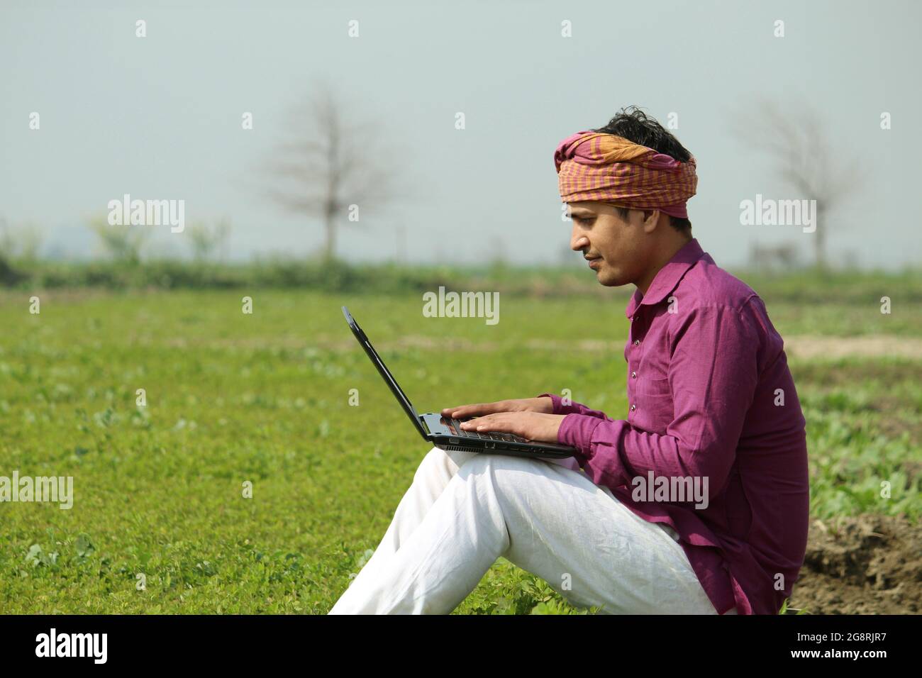 farmer using laptop in agriculture field Stock Photo - Alamy