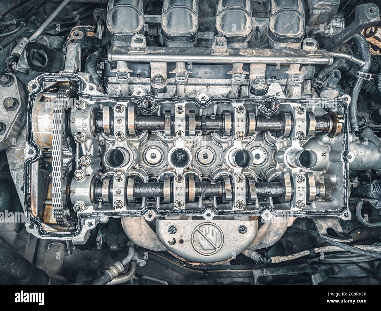 Top view of the engine cylinder under the car hood in the daylight ...
