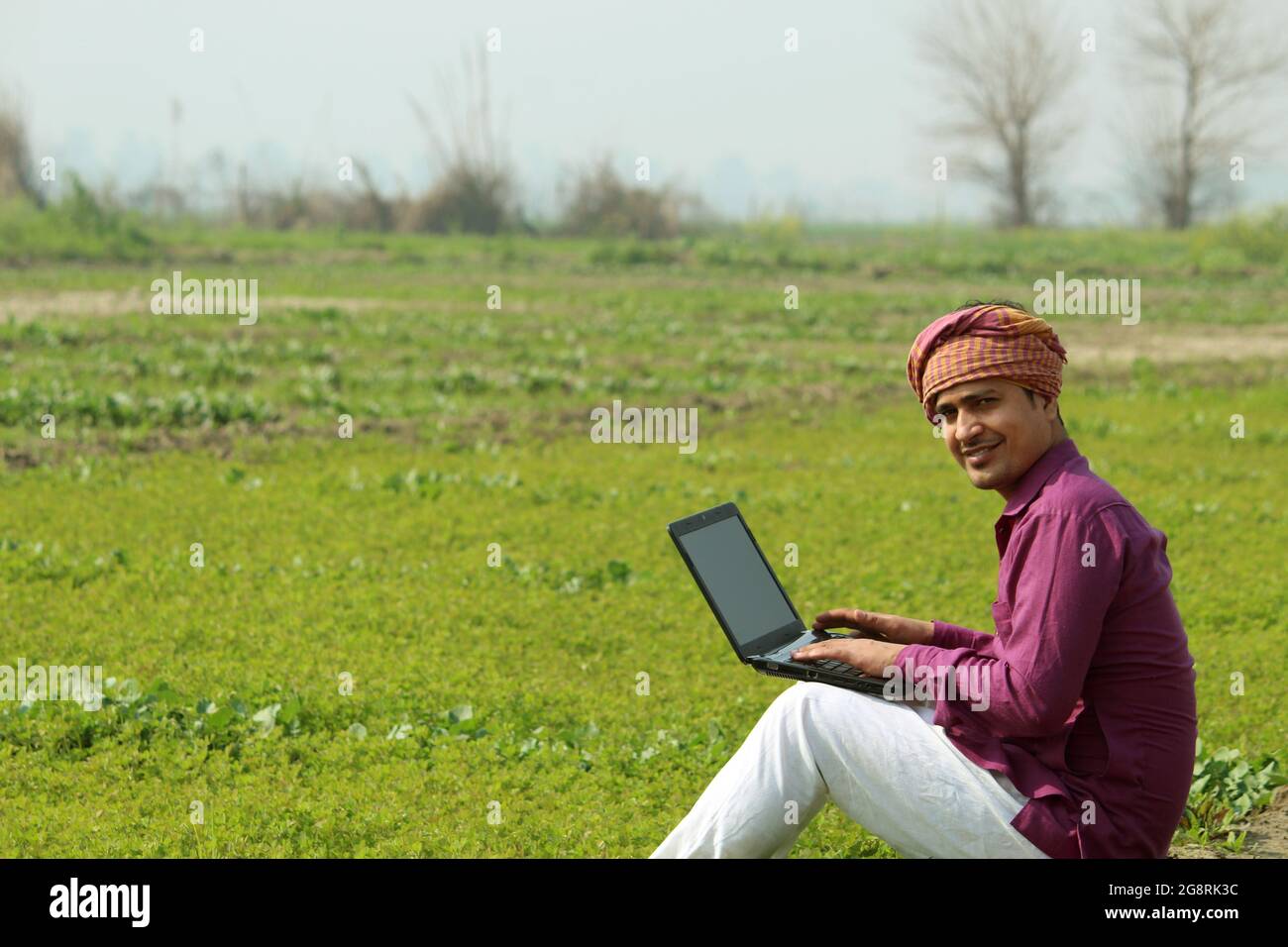 farmer using laptop in agriculture field Stock Photo - Alamy
