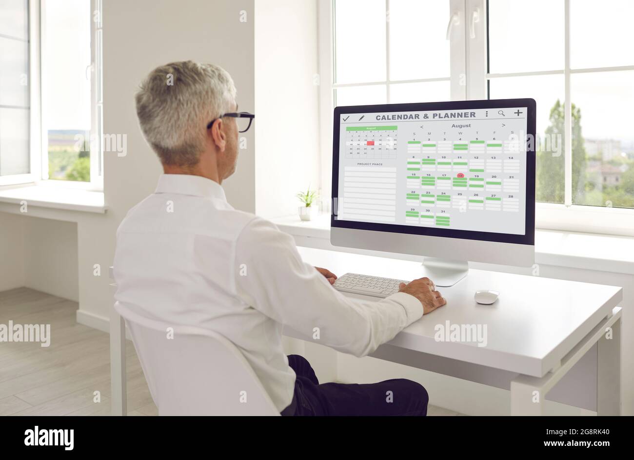 Senior manager organizing schedule using Calendar and Planner on office ...