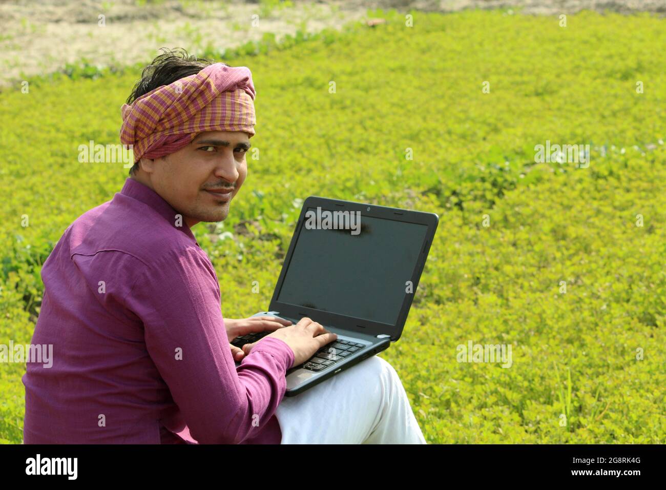 farmer using laptop in agriculture field Stock Photo - Alamy