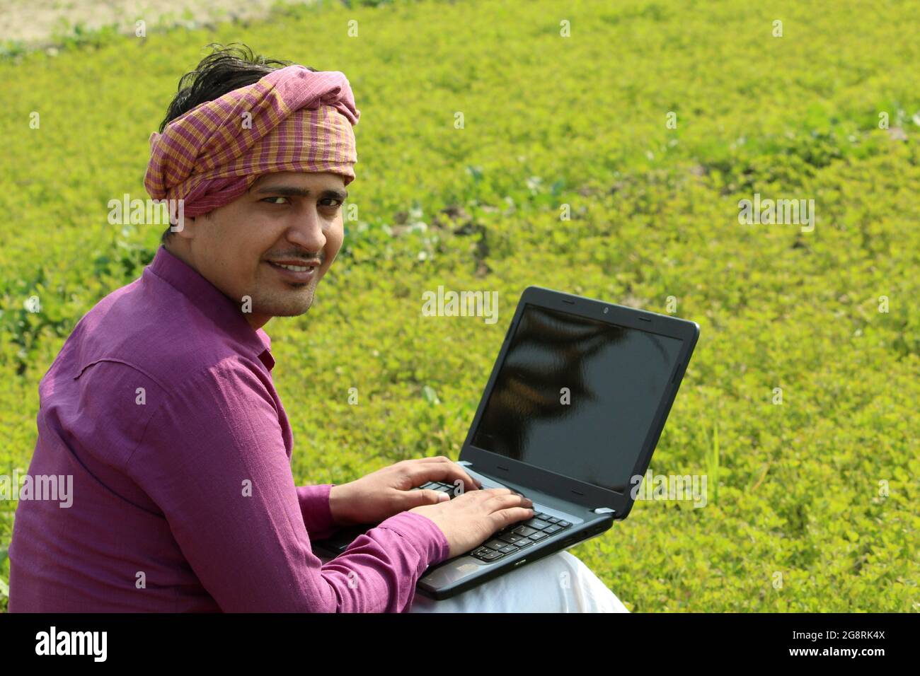 farmer using laptop in agriculture field Stock Photo - Alamy