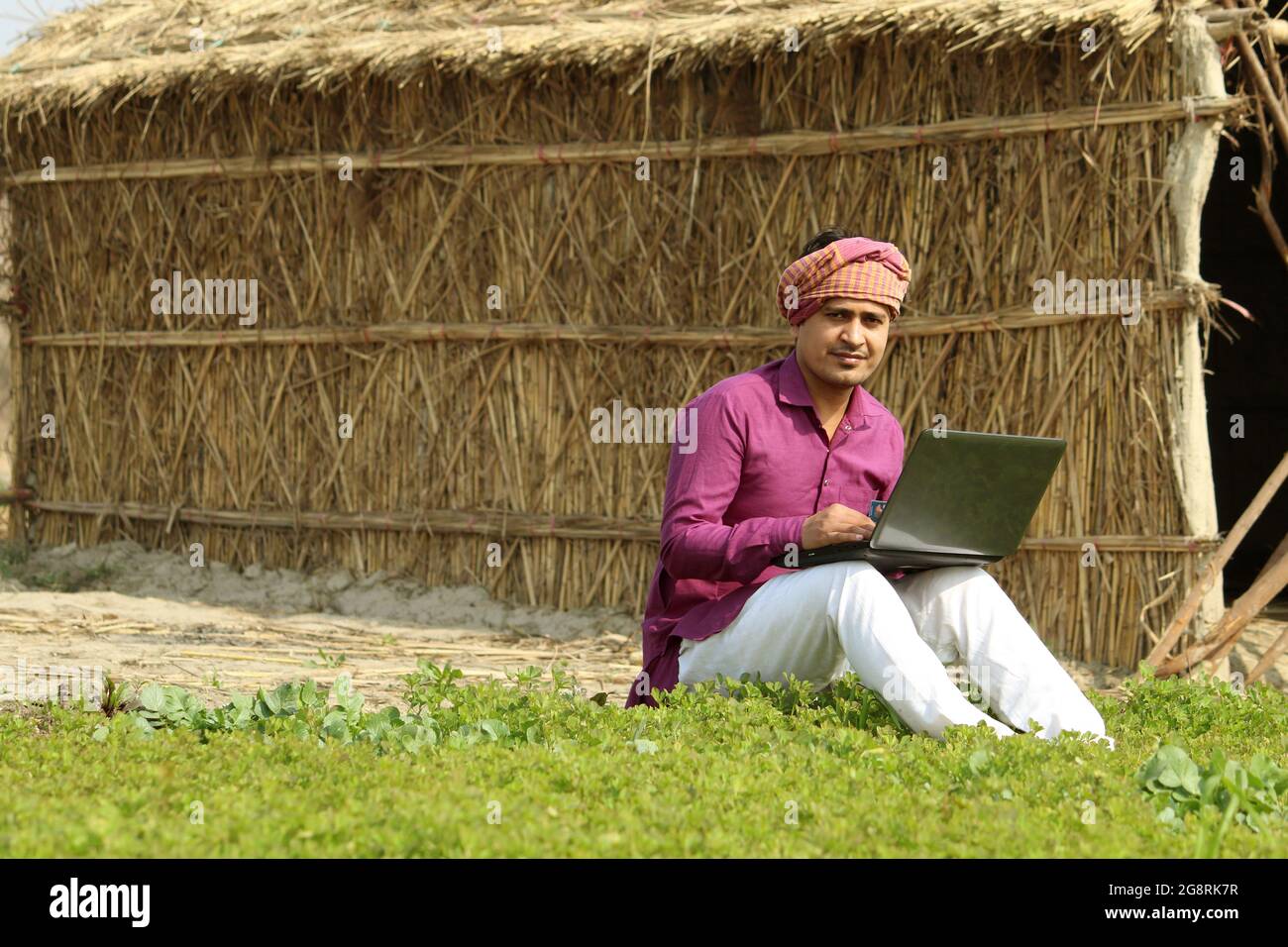 farmer using laptop in agriculture field Stock Photo - Alamy
