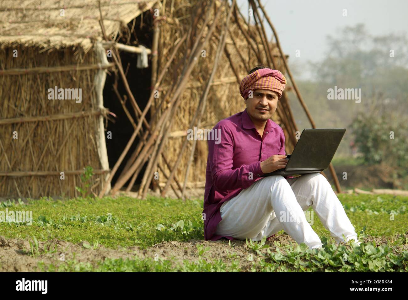 farmer using laptop in agriculture field Stock Photo - Alamy