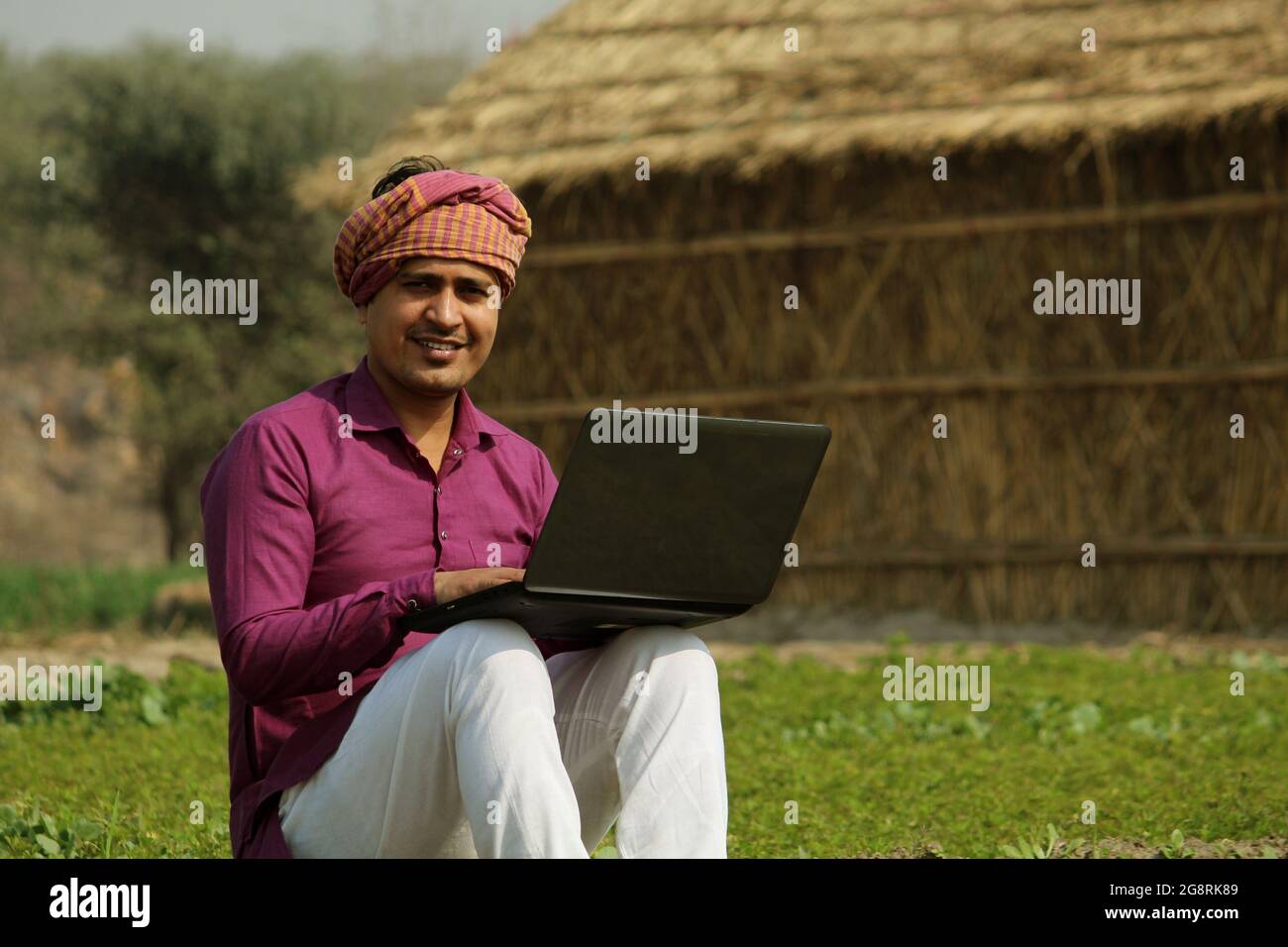 farmer using laptop in agriculture field Stock Photo - Alamy
