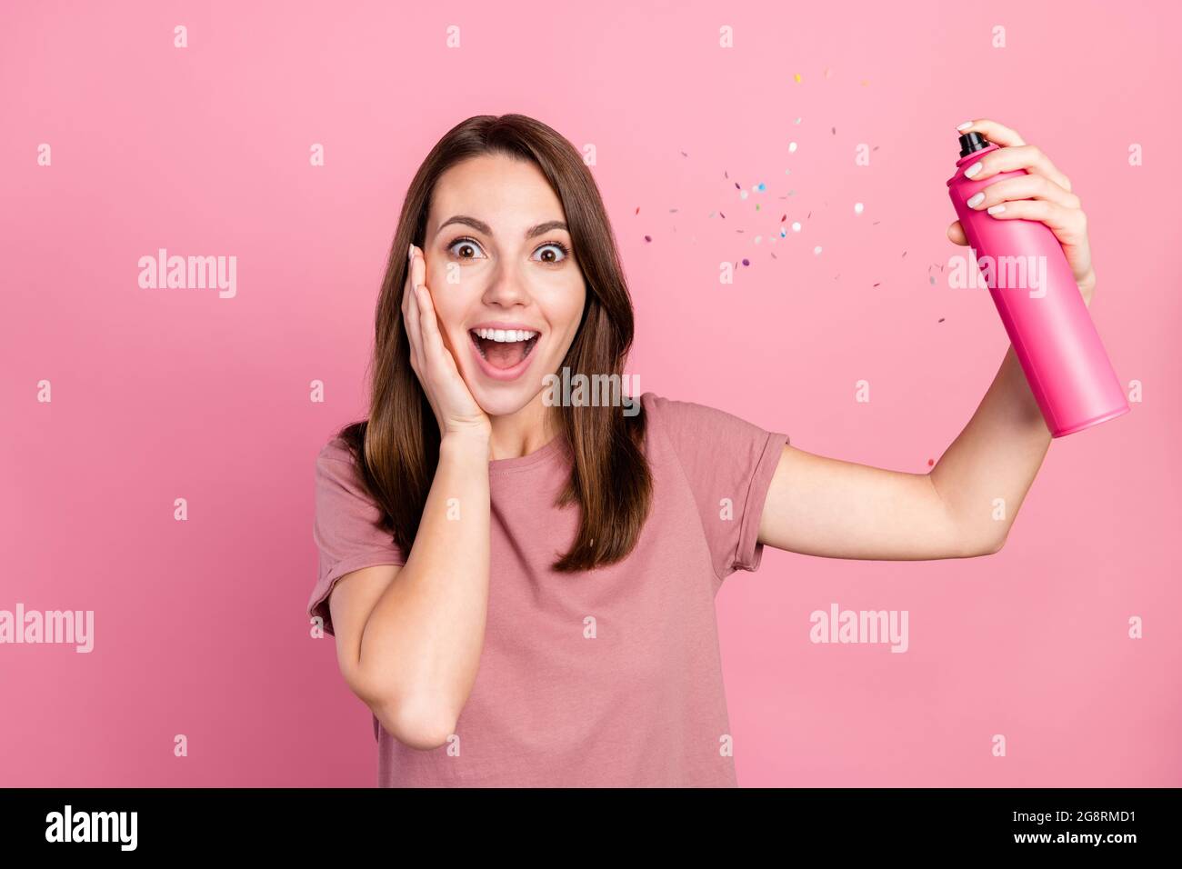 Photo of young girl happy positive smile fly air confetti aerosol spray ...