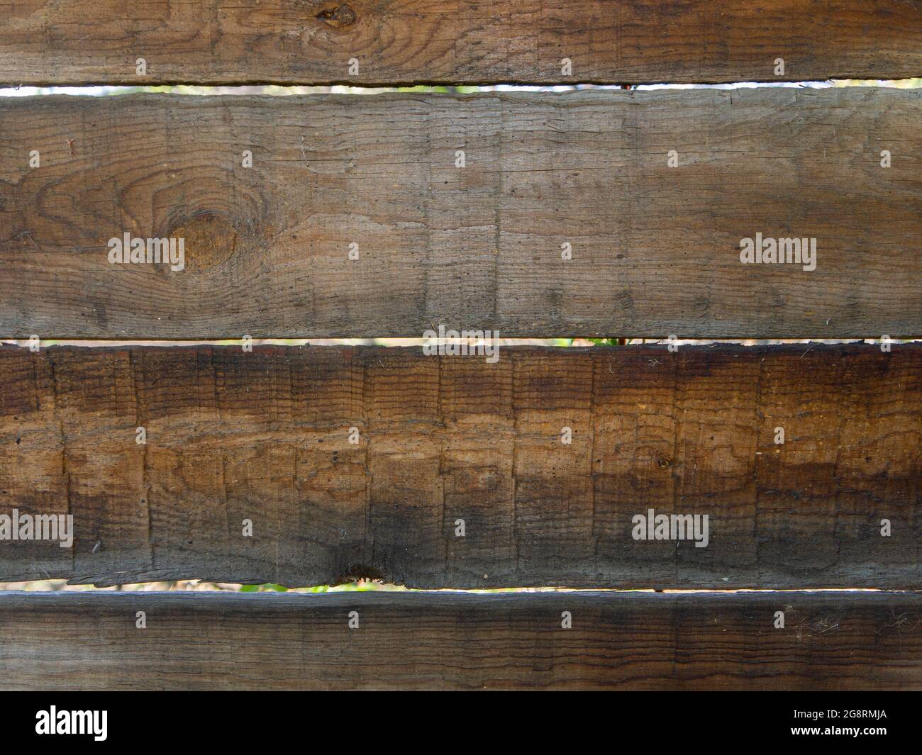 Background looks like old wooden farm wall. The wall of the village ...