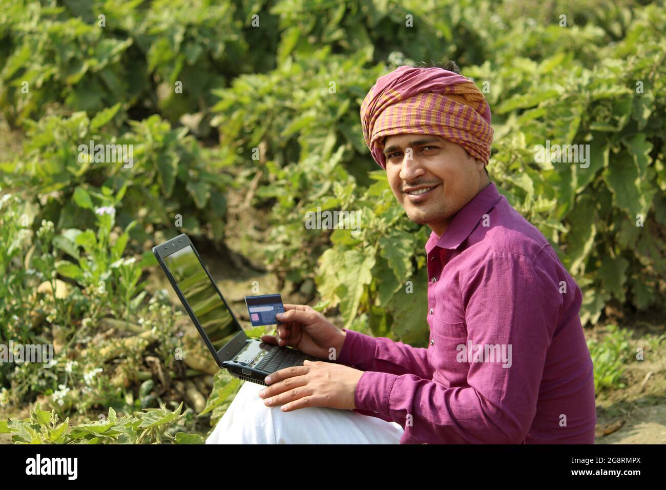 farmer,indian farmer,using laptop in agricultural field Stock Photo - Alamy