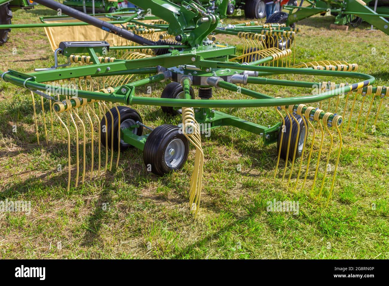 Russia, Leningrad Region - June, 2019: brand Krone rotary rakes at the ...