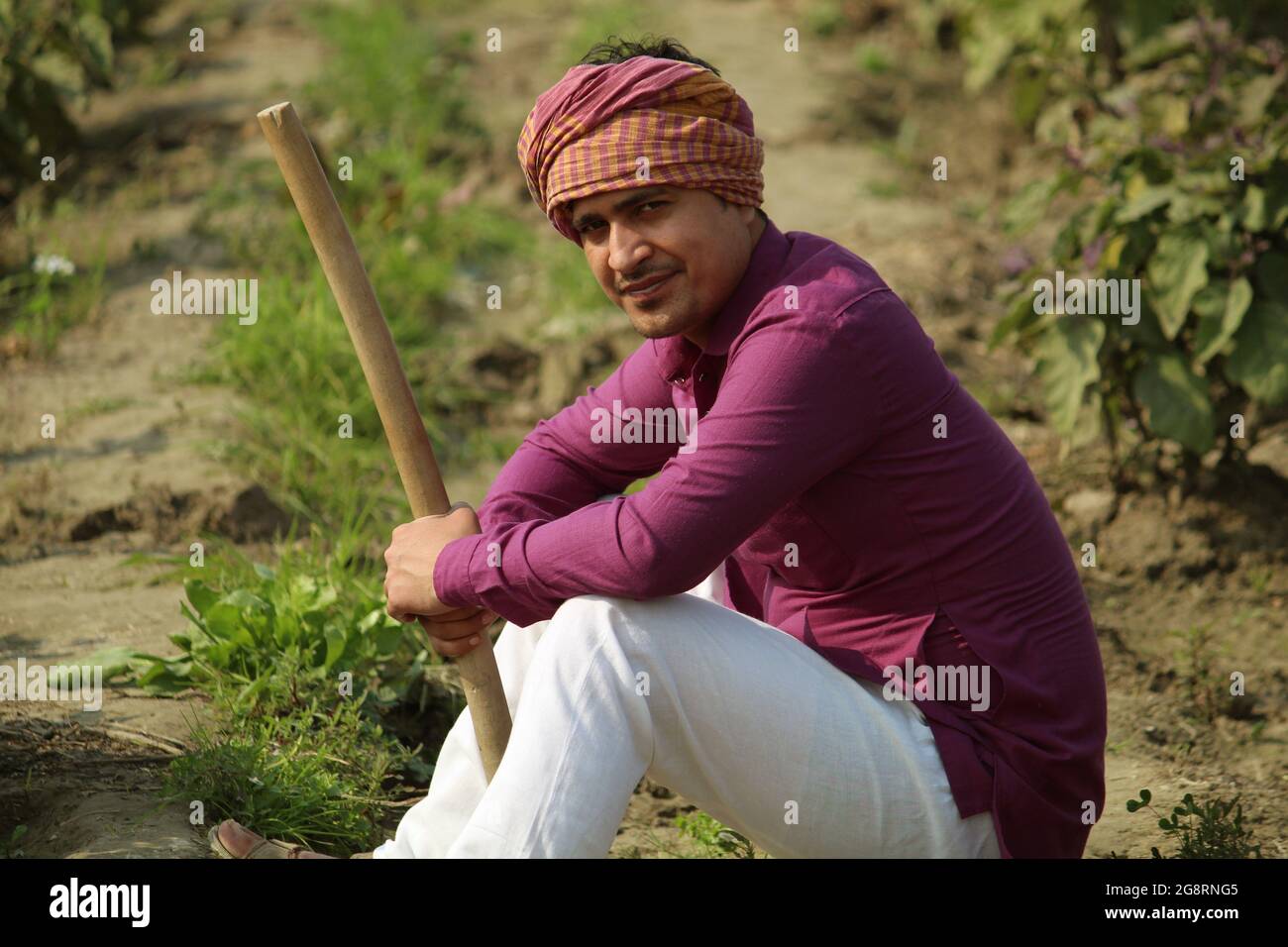 farmer,sitting in agricultural field Stock Photo - Alamy