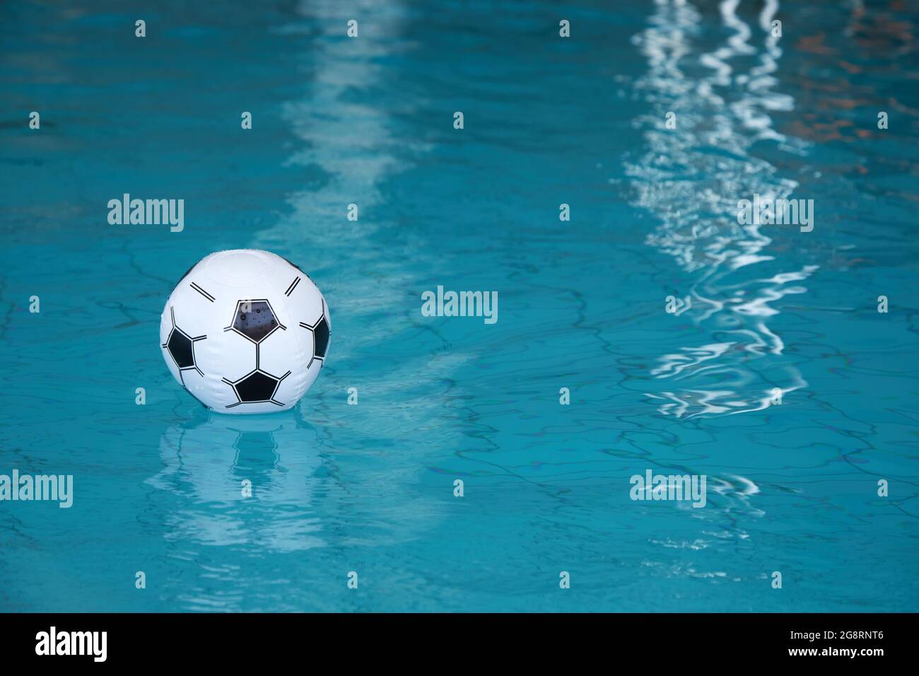 Beach ball in pool. Inflatable ball floating in swimming pool Stock ...