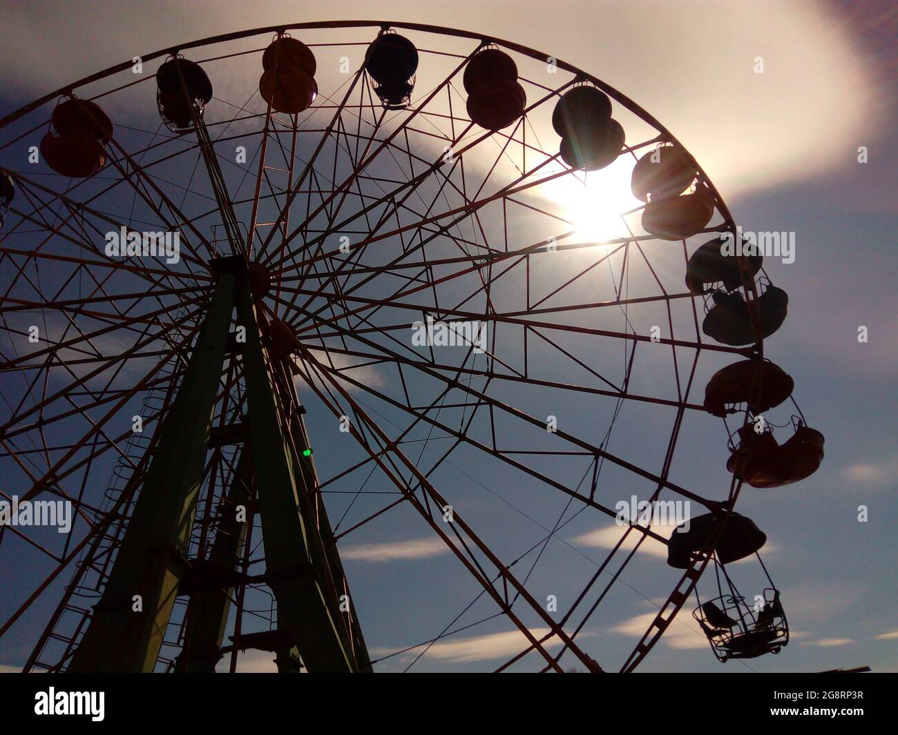 Bright sun and ferris wheel in spring. The concept of leisure and ...