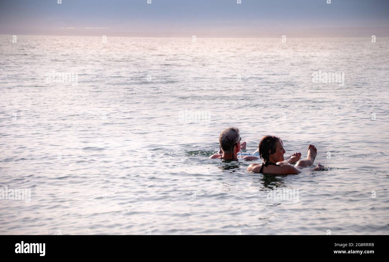 Dead Sea, Amman, Jordan. - 04 Apr 2014: Two tourist relaxing and ...