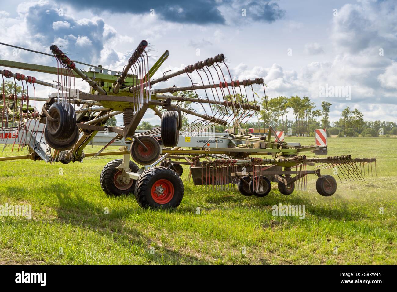 Russia, Leningrad Region - June, 2019: brand Krone rotary rakes at the ...
