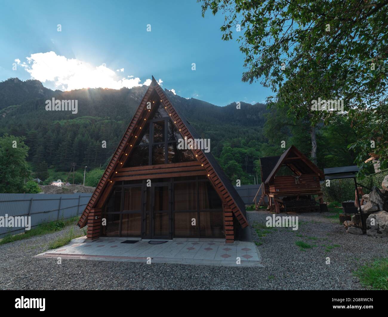 triangular wooden house in the mountains against the background of the ...