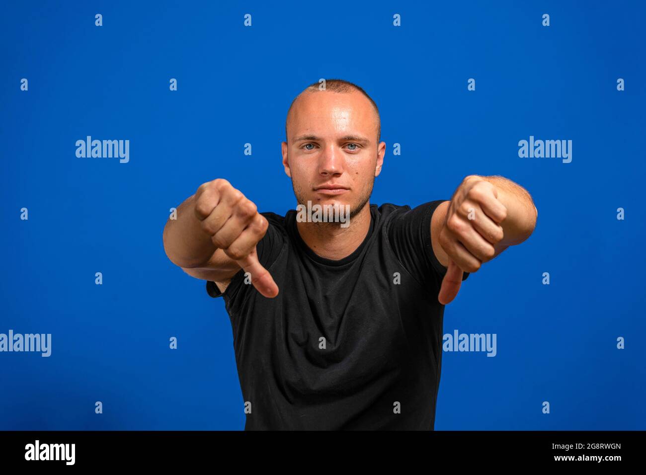 Caucasian attractive young man with blue eyes serious and angry with ...