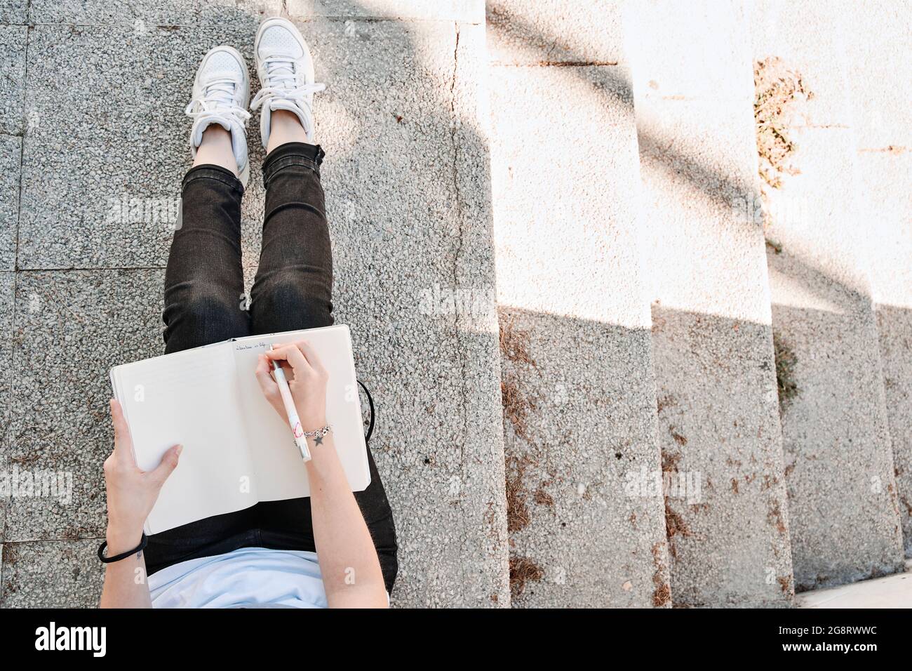 top view of a girl reading a book on the staircase, with copy space ...