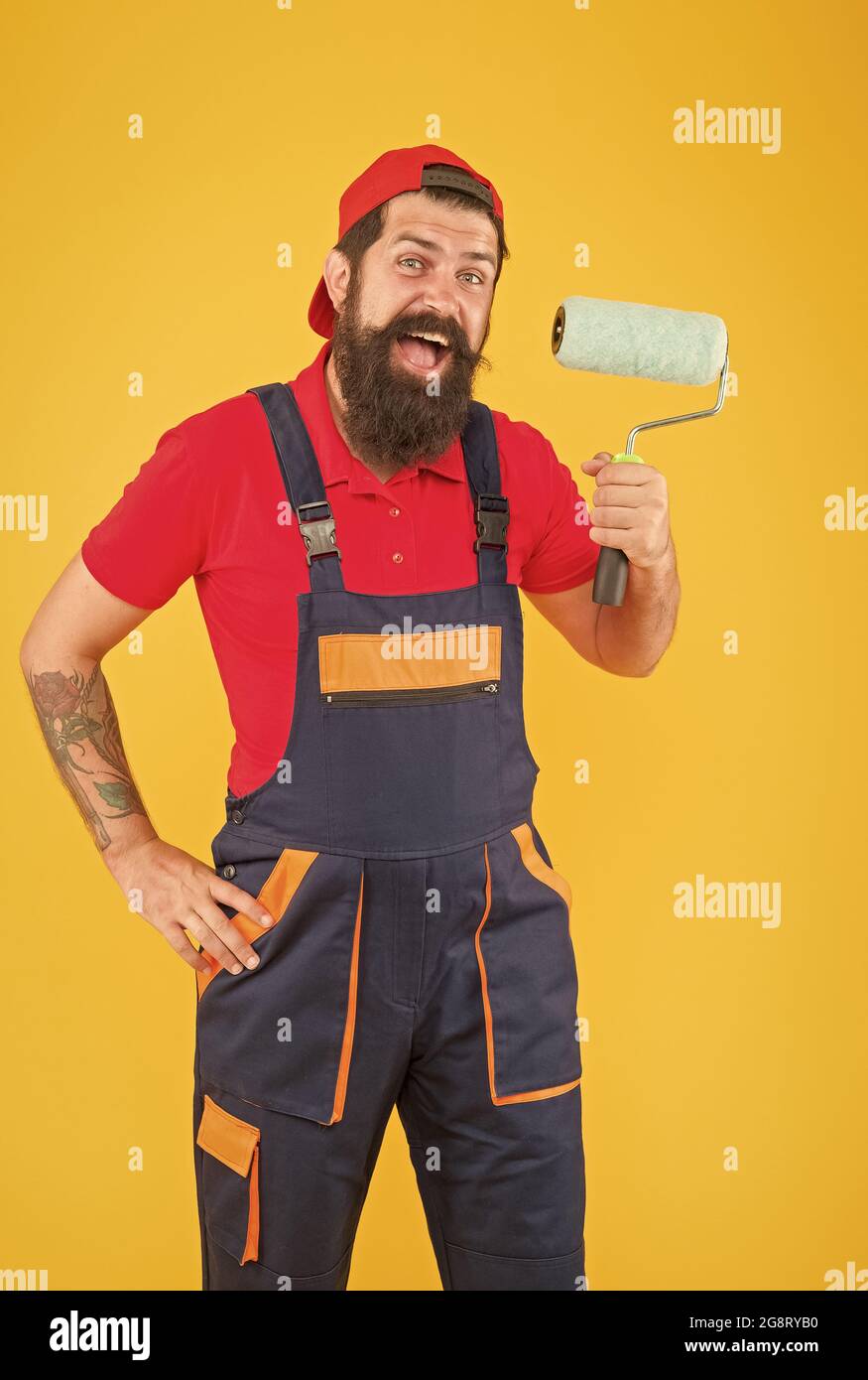 surprised bearded male painter worker in boiler suit uniform using ...