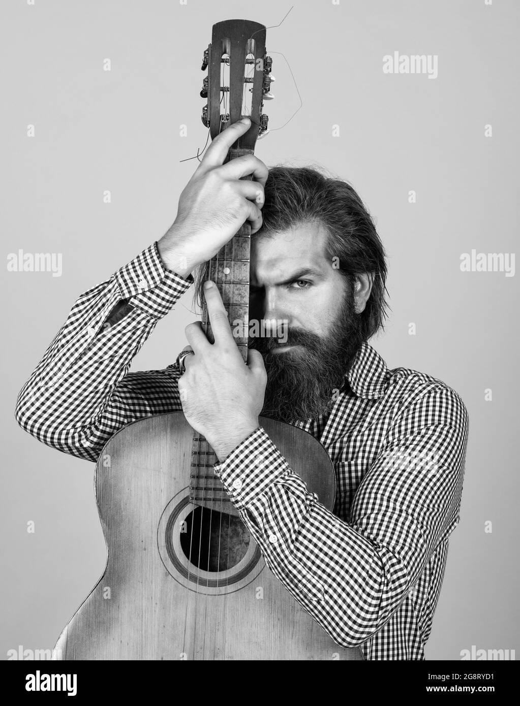 Confident and stylish. brutal caucasian guy playing guitar. country ...