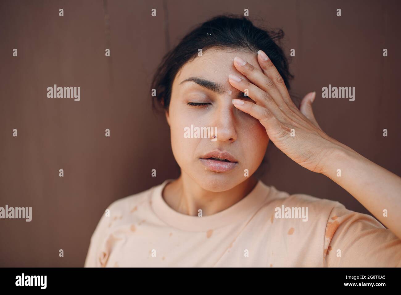Stressed woman with sweat drops on her face suffering of heatstroke ...