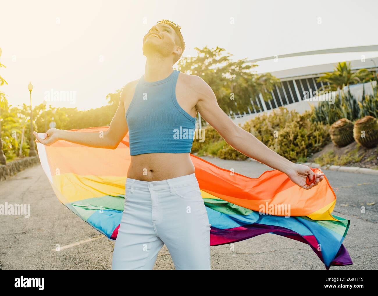 Happy gay with LGBT flag on street in summer Stock Photo - Alamy