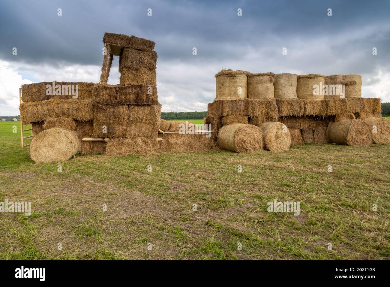 tractor from straw bales in the field Stock Photo - Alamy