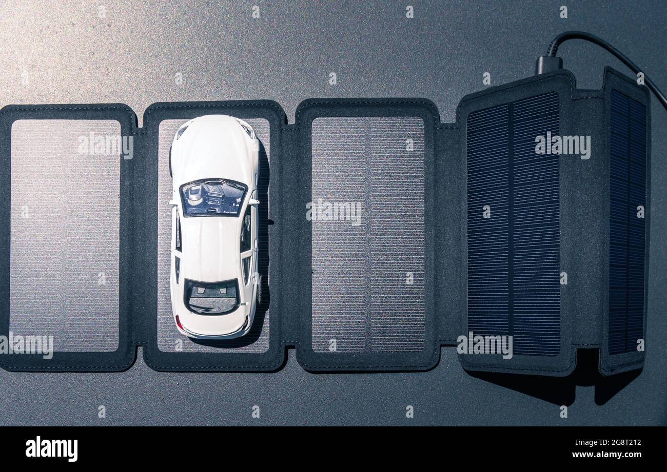 Toy car on top of a solar panel. Solar powered electric car and ...
