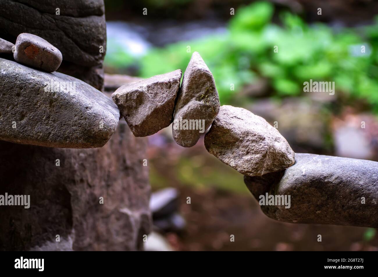 Rock bridge, pyramid, rock balancing art. Close-up of a stack of stones ...
