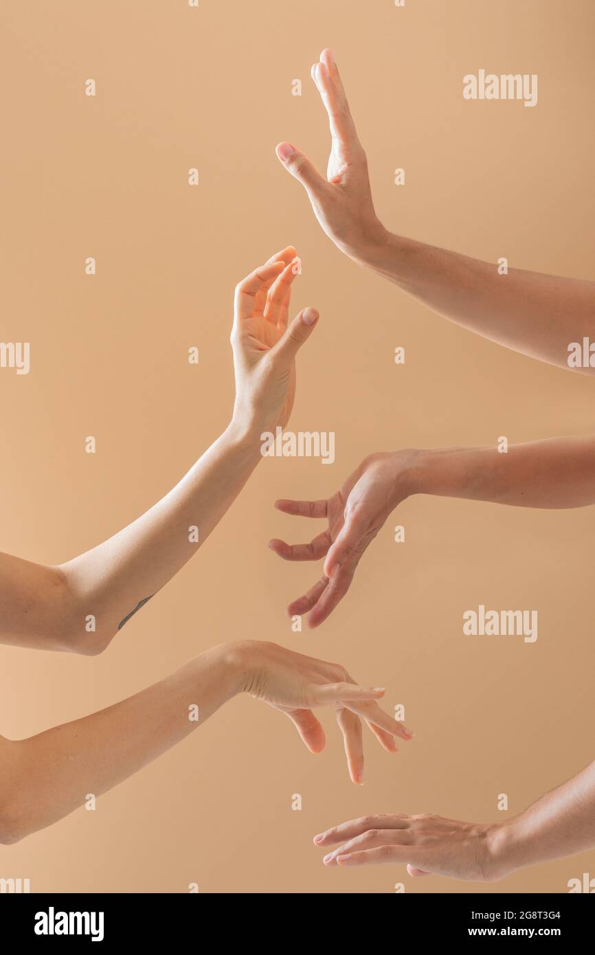 Vertical shot of four soft fragile female hands dancing in the air ...