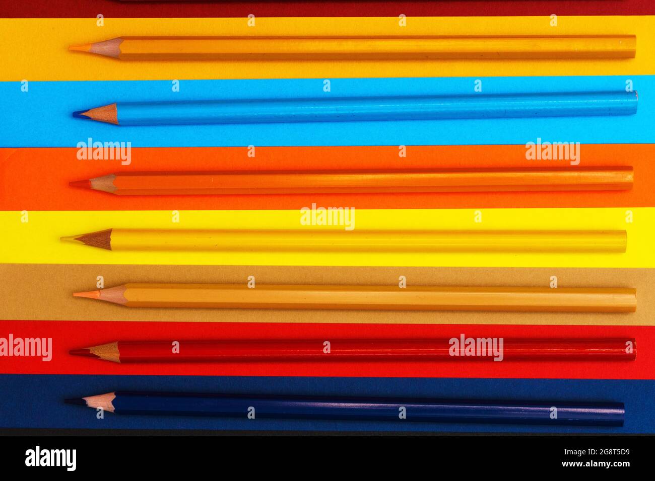 Colored pencils on a multi-colored background. Many pencils of ...