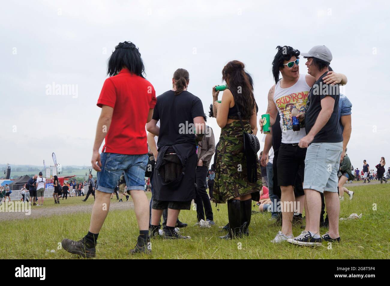 Small group of friends at an outdoor festival event Stock Photo - Alamy