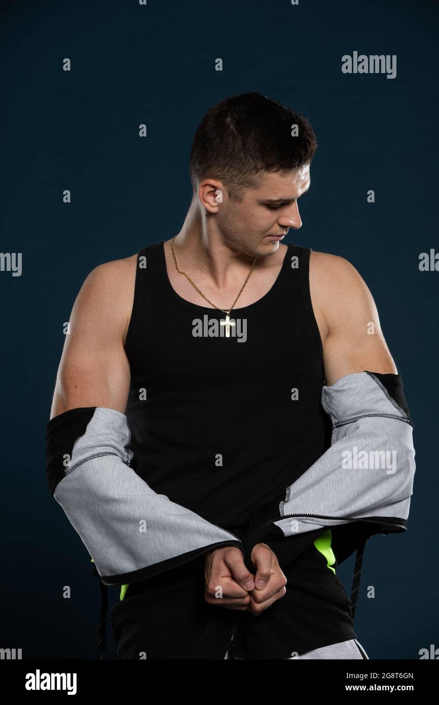 An athlete shows off his muscles by flexing his arm muscles after a ...