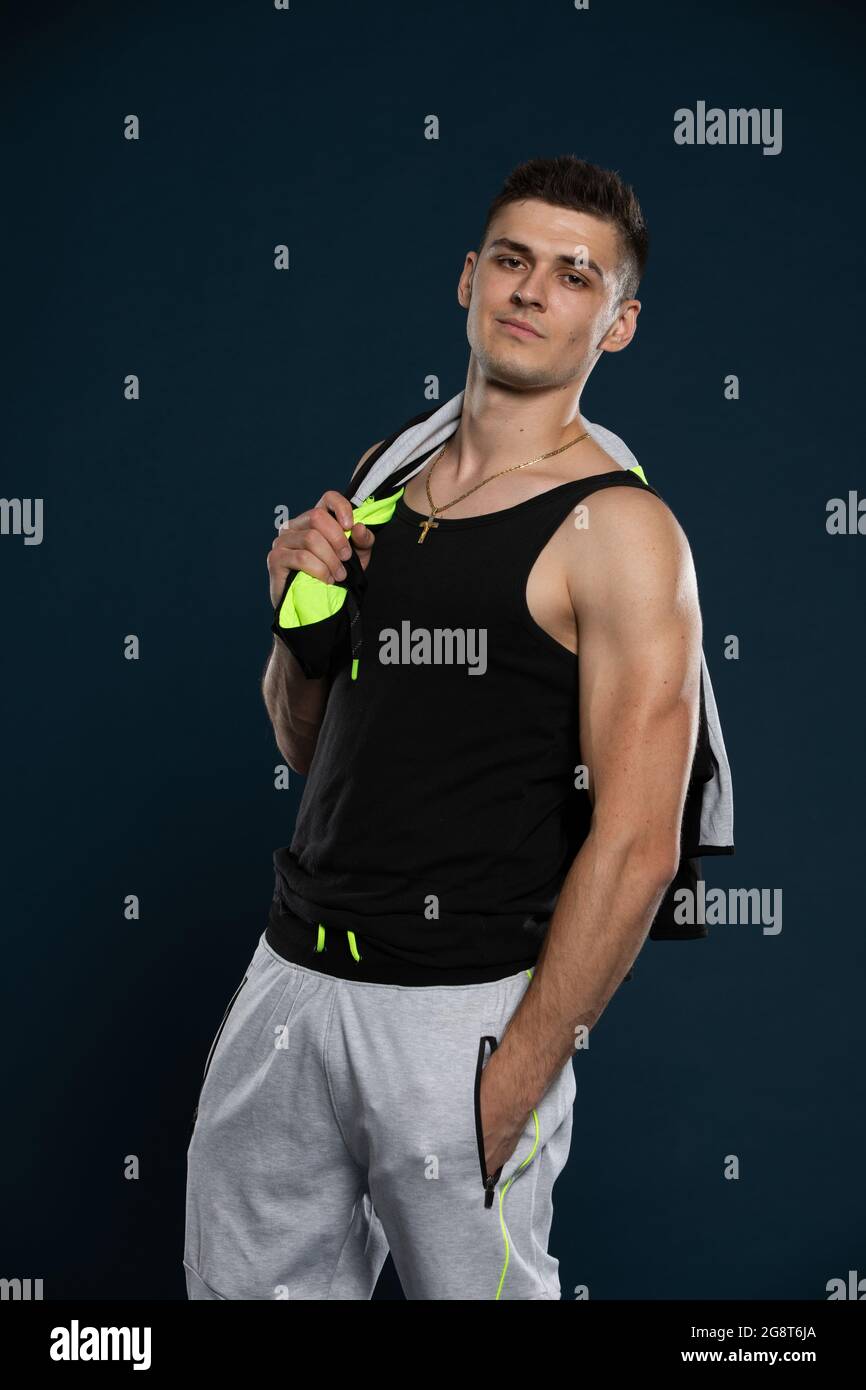 An athlete shows off his muscles by flexing his arm muscles after a ...