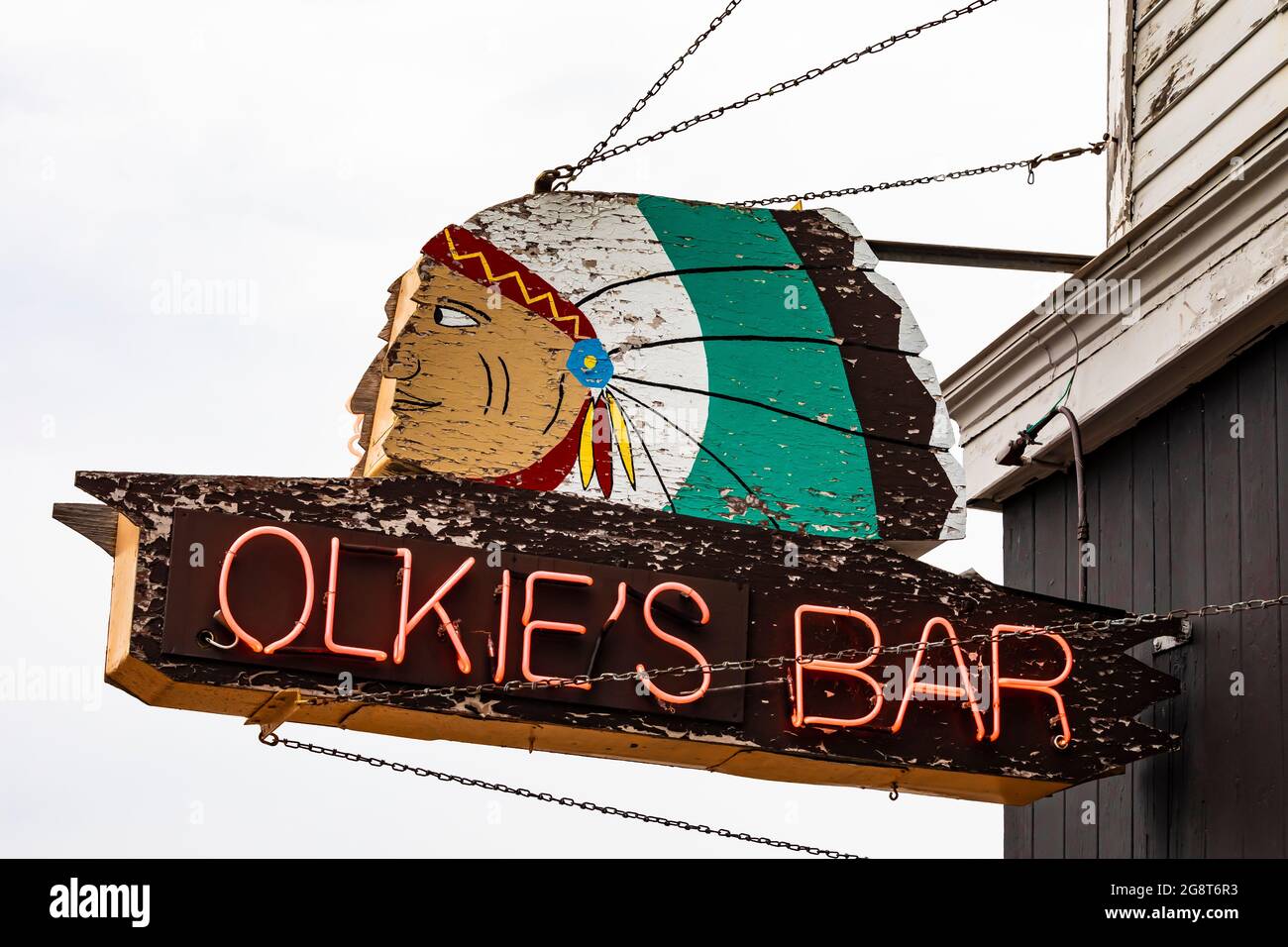 Sign for Olkie's Bar, featuring a Plains Indian on its sign, in ...