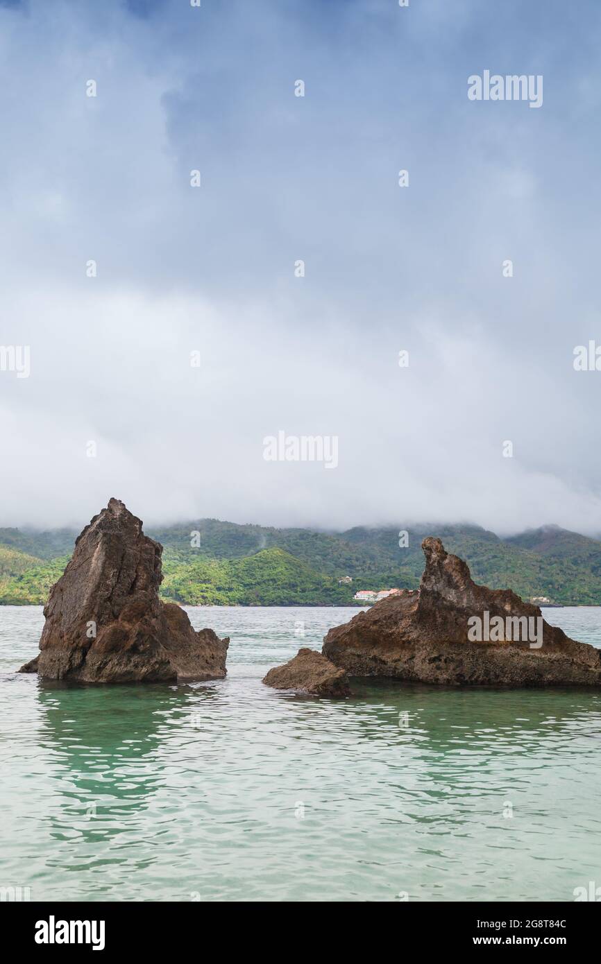 Samana bay, vertical landscape with sharp coastal rocks under cloudy ...