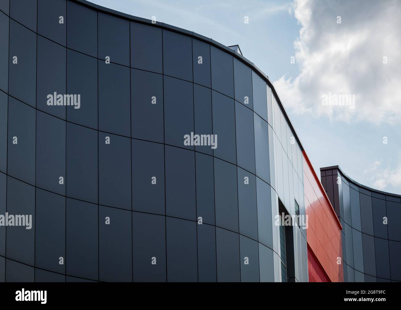 curved shape of a modern building. metal panels of the shopping center ...