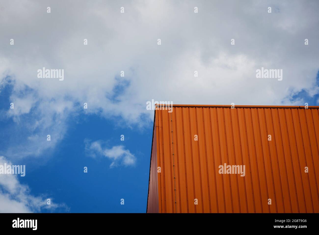 metallic cladding on modern industrial building over sky background ...
