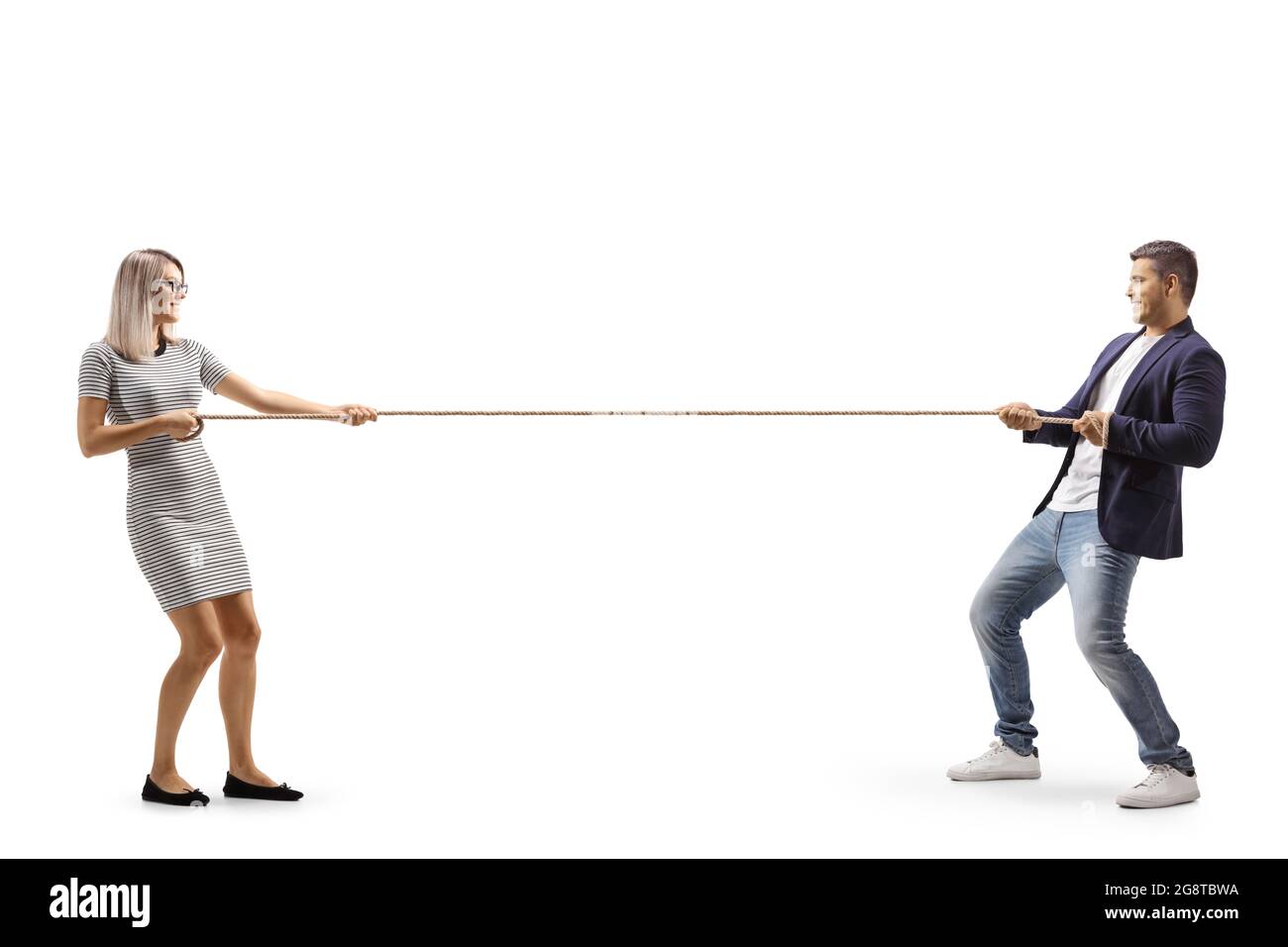 Full length profile shot of a young man and woman pulling a rope ...