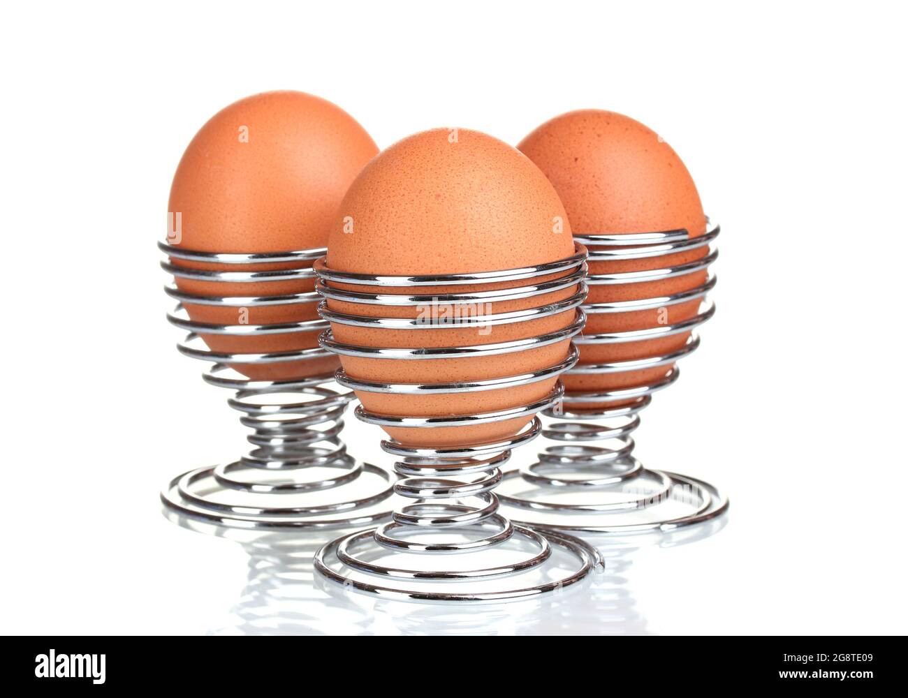 boiled eggs in metal stands isolated on white Stock Photo - Alamy