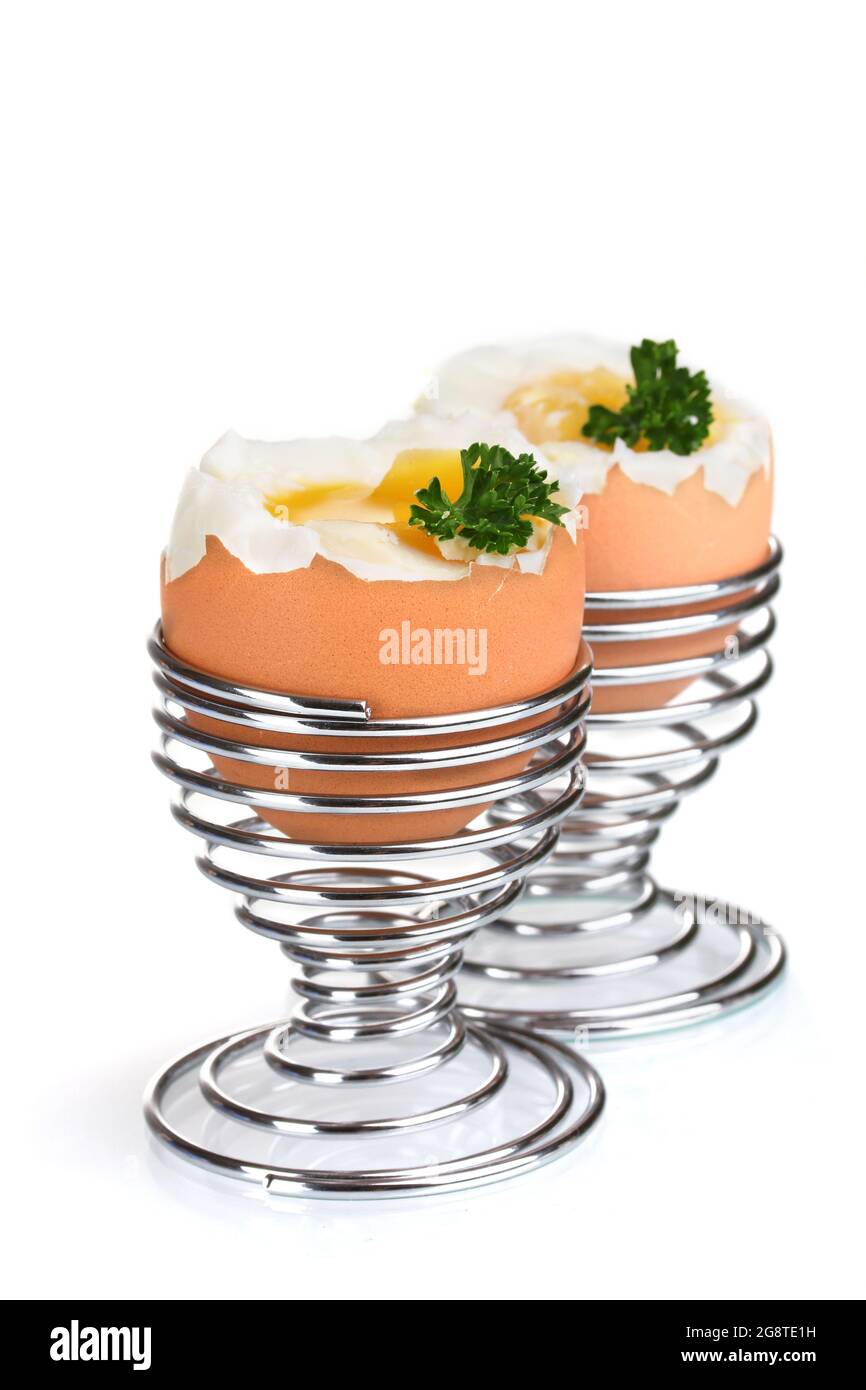 boiled eggs in metal stands and parsley isolated on white Stock Photo ...