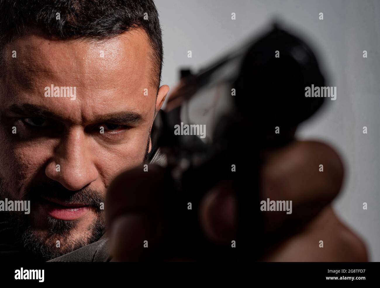 Need for revenge. Close up gun barrel. Killer or murderer concept. Head ...